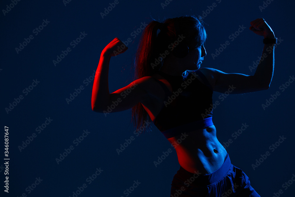 Embossed internal oblique muscles of the abs, illuminated by blue neon ...