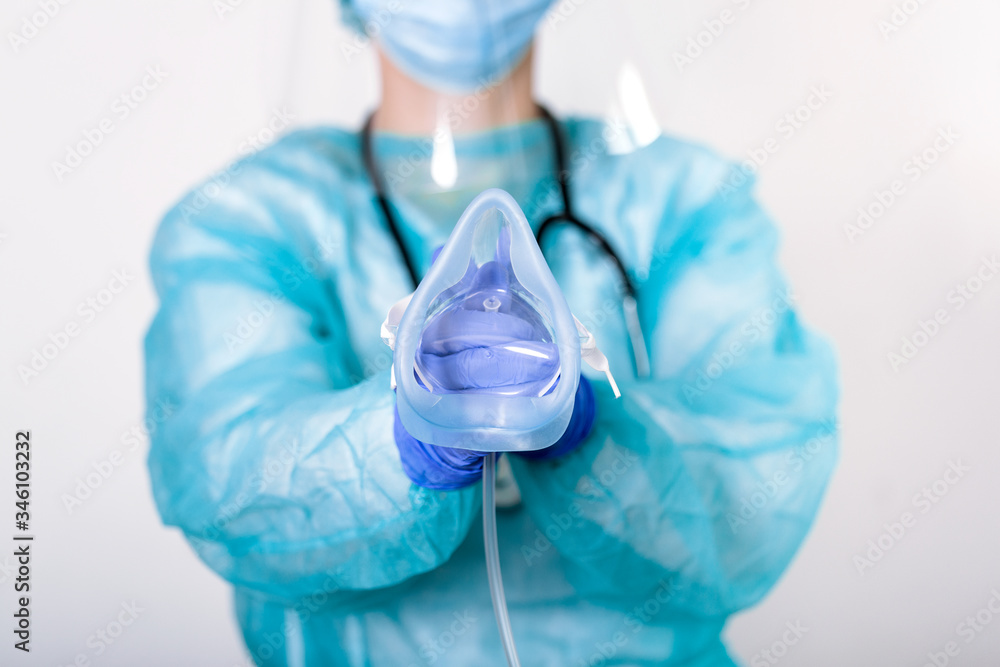 Doctor holding up oxygen mask as if to put on patient in hospital ...