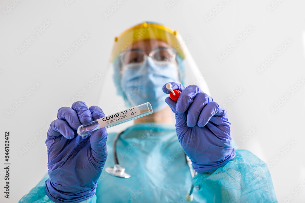 Female caucasian doctor holding a swab collection stick, nasal and oral ...