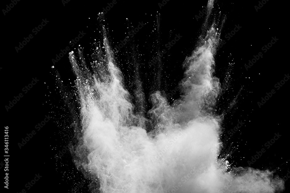 White powder explosion isolated on black background.White dust ...
