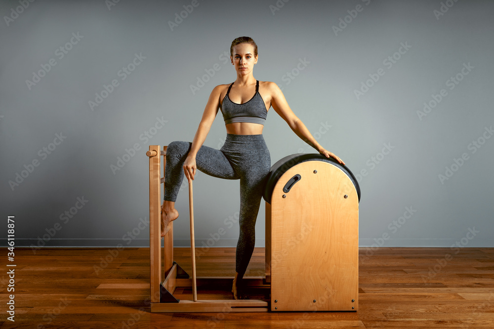 Pilates trainer exercises on a pilates barrel. Body training, perfect ...