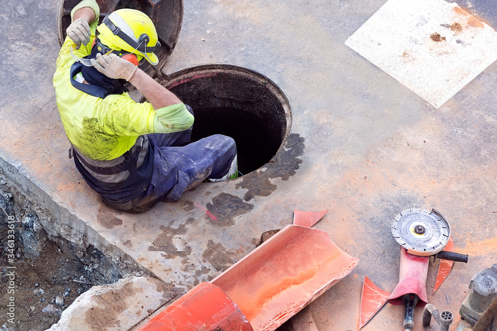 sewer utility worker for cleaning and repairing sewerage pipes in ...