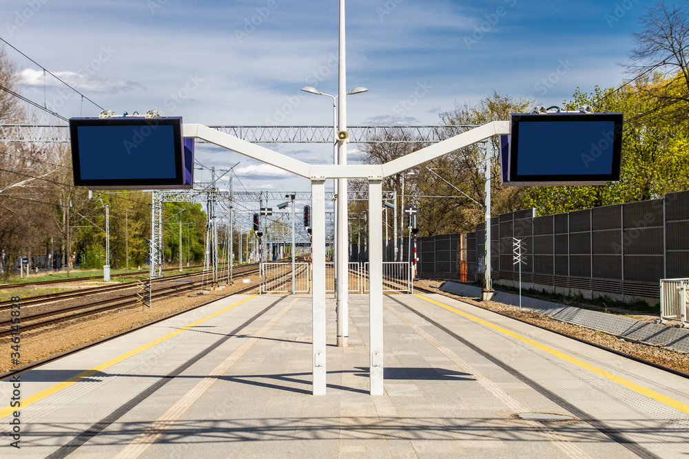 Railway platform in the center are two screens. with the train arrival ...