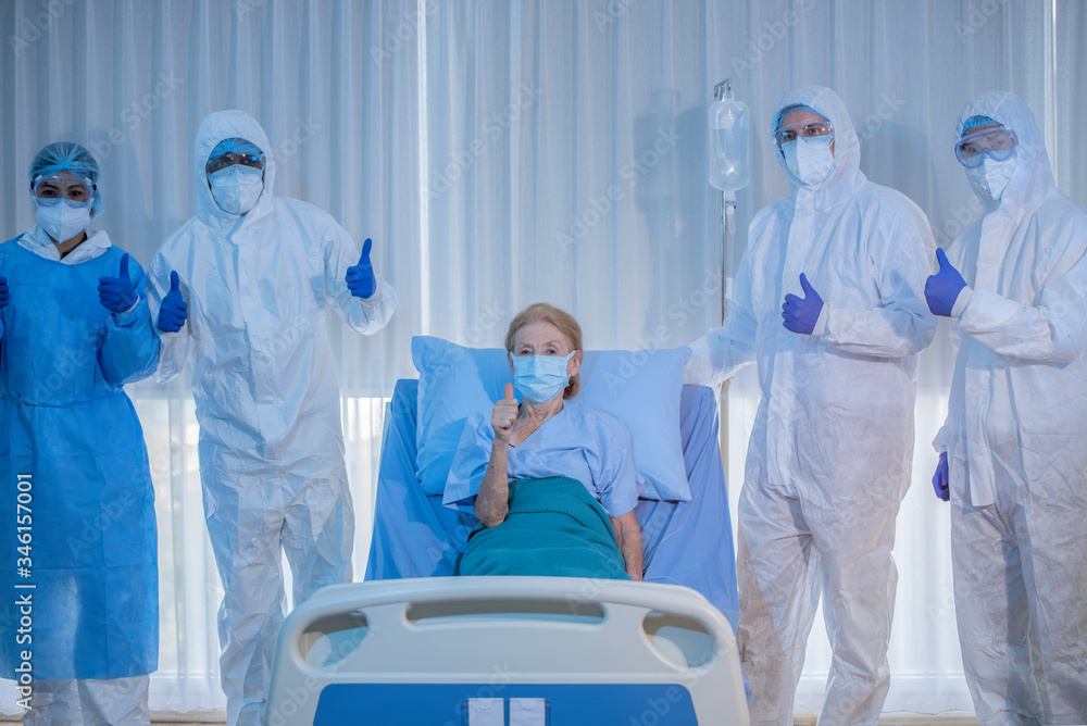 A senior caucasian and medical teamwork all, thumbs up, happy that the ...