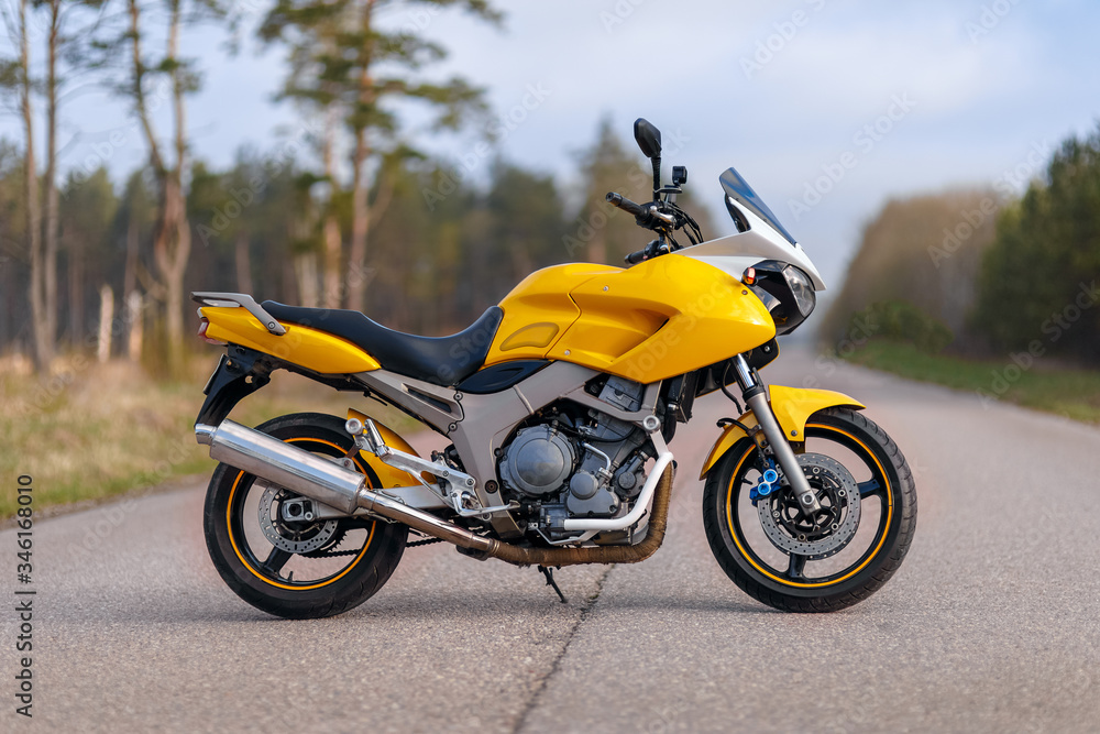 Yellow motorcycle on the road Stock Photo | Adobe Stock