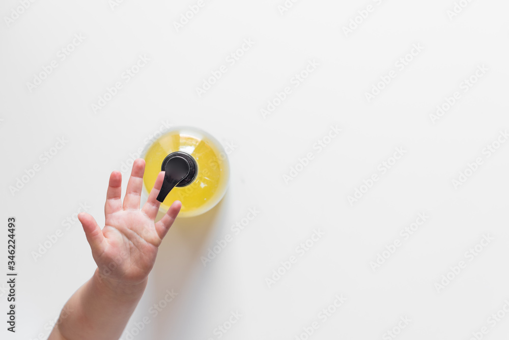 baby child washing hands with antibacterial liquid soap dispenser ...