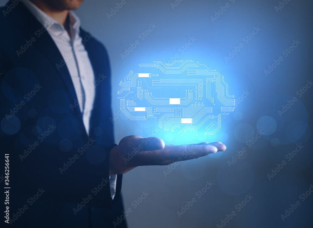 Brain with PCB design and businessman pointing brain microchip ...