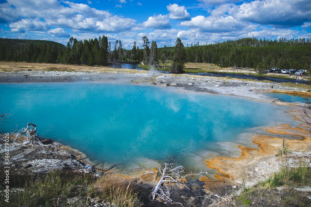 Basin with blue shade of thermal microorganisms inside with orange ...