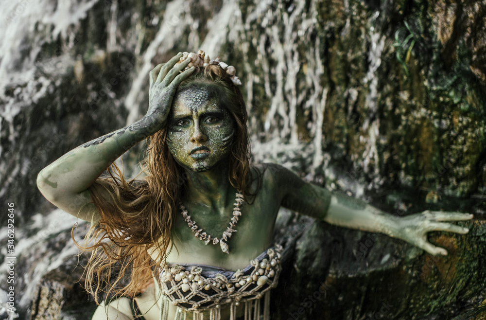 girl mermaid amphibian with green skin with body art with a necklace ...