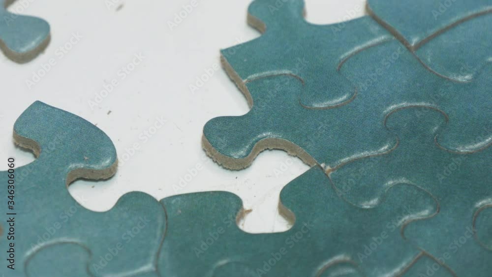 Jigsaw puzzle - two clips: one piece is inserted then the puzzle is ...
