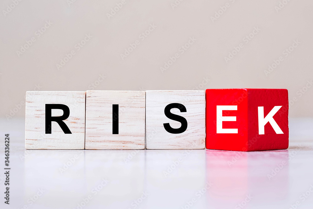 flipping wooden cube blocks with RISK change to RISE text on table ...