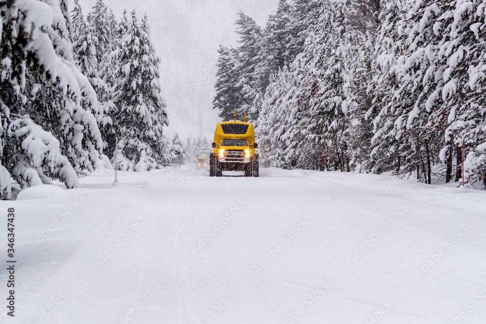 Heavy duty snow bus vehicle plows over snow of Highway 20 in ...