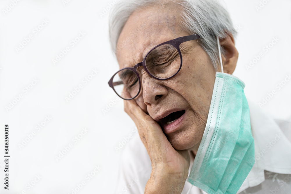 Sad senior woman holding her hand on her aching tooth,asian elderly ...
