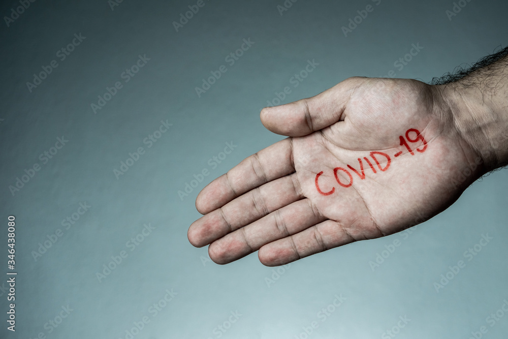 Covid-19 text written on hand of man. Covid-19, Coronavirus, SARS-CoV-2 ...