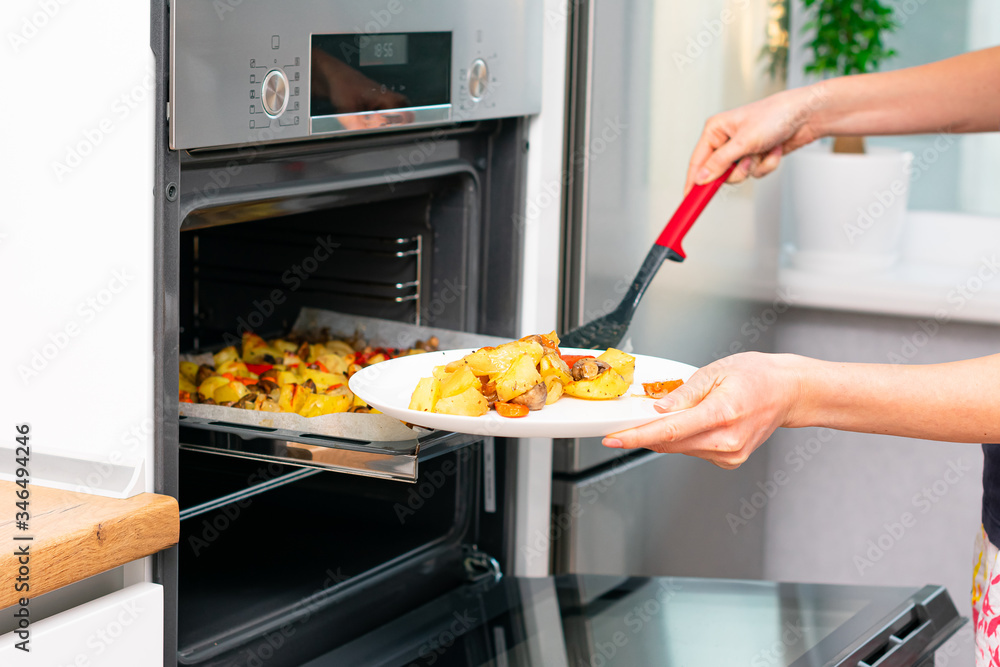 Cooking in the kitchen in the electric oven. Electric oven with hot air ...
