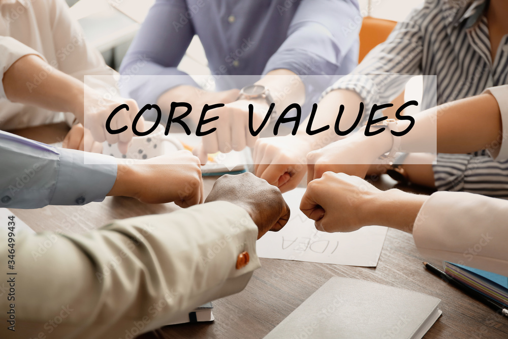 Core values concept. People putting hands together at table, closeup ...