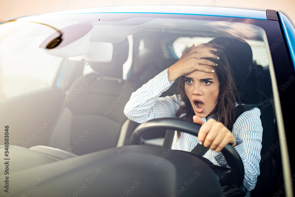 Furious woman stucked in traffic jam. A furiously angry woman driving ...