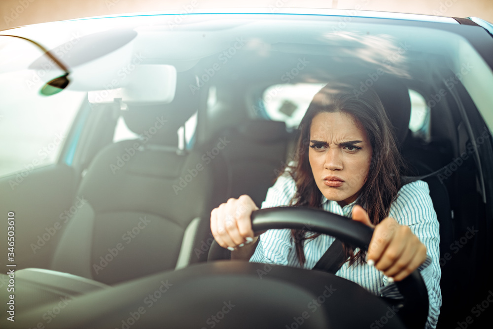 Road rage! Enraged young woman driver shouts and points accusingly ...