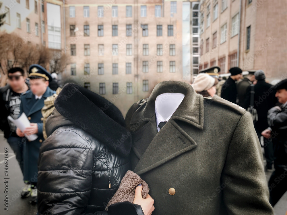 Soldier in formal military coat stand with woman in jacket without ...