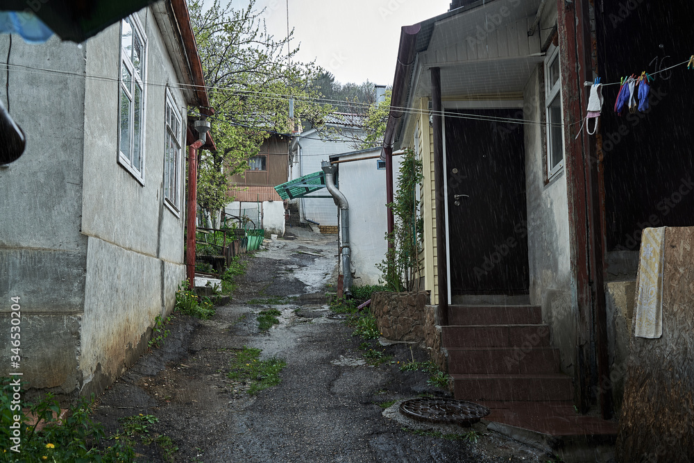 Slums of Russia. Old poor street in the rain. The resort city of Russia ...