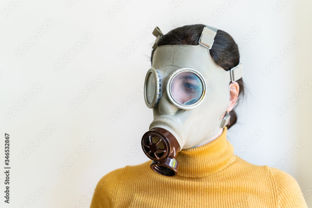 Horizontal side view of woman with gas mask at home isolated on white ...