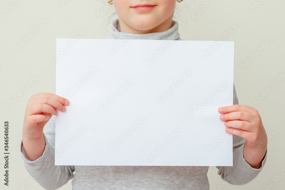 Mockup empty sheet of paper in hands of little girl. Hands of child ...