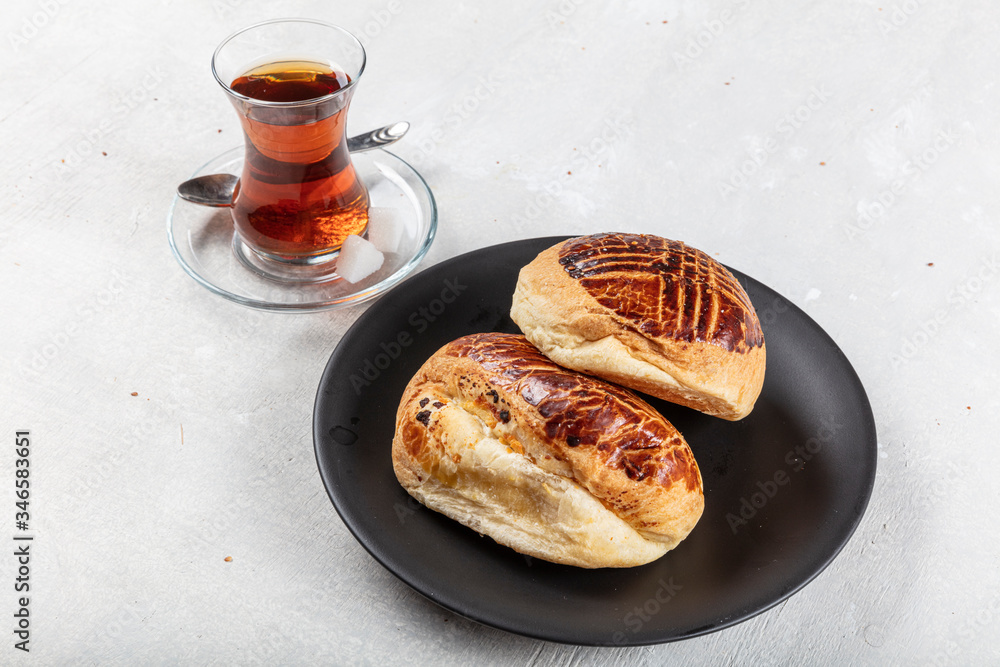 Turkish Pastry Pogaca with Tea / Cay on white wooden surface ...