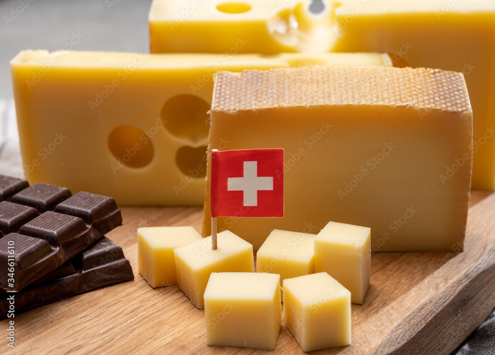 Tasty Swiss food, block of medium-hard yellow cheese emmental or ...