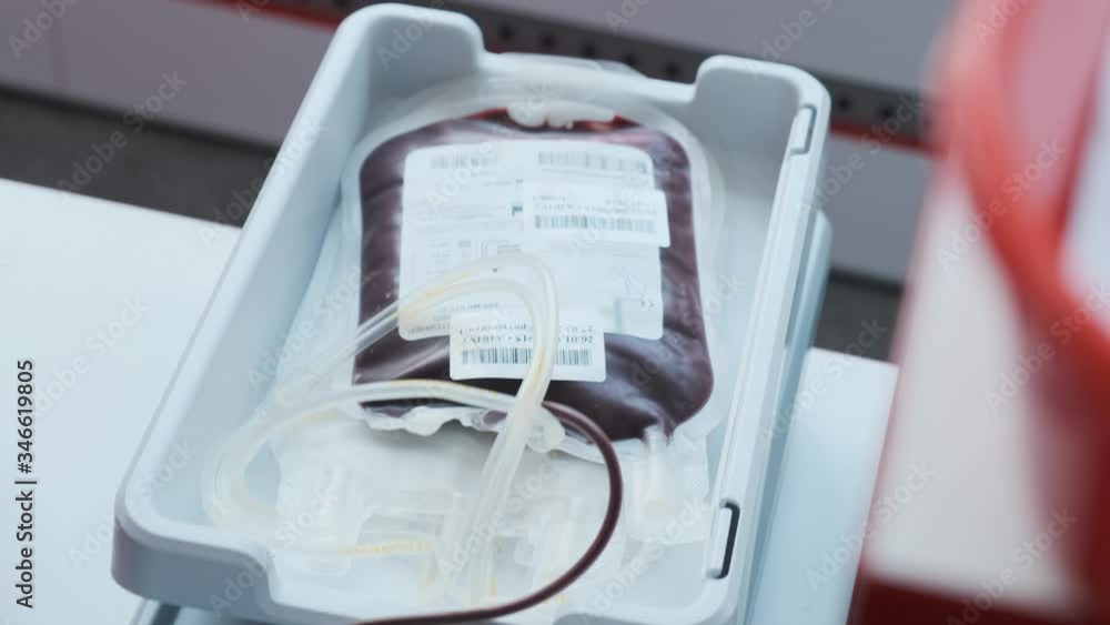 Plastic bag with tubes filled with blood. Blood package. Blood ...