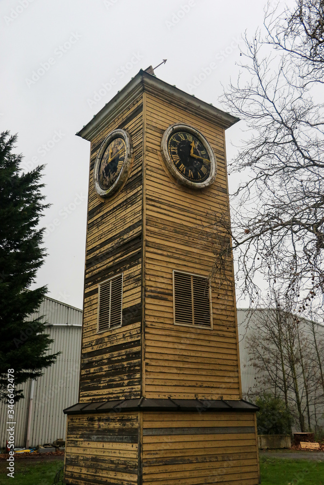 A late Gregorian period wooden clock tower with peeling paint and gold ...