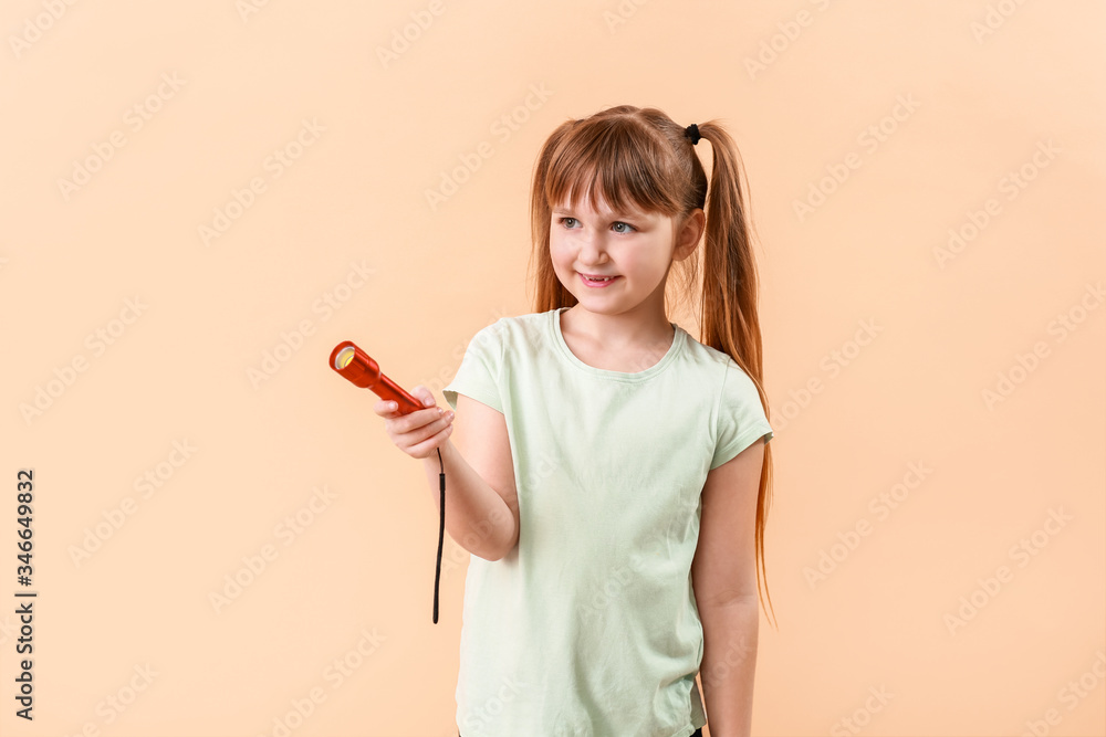 Little girl with flashlight on color background Stock Photo | Adobe Stock