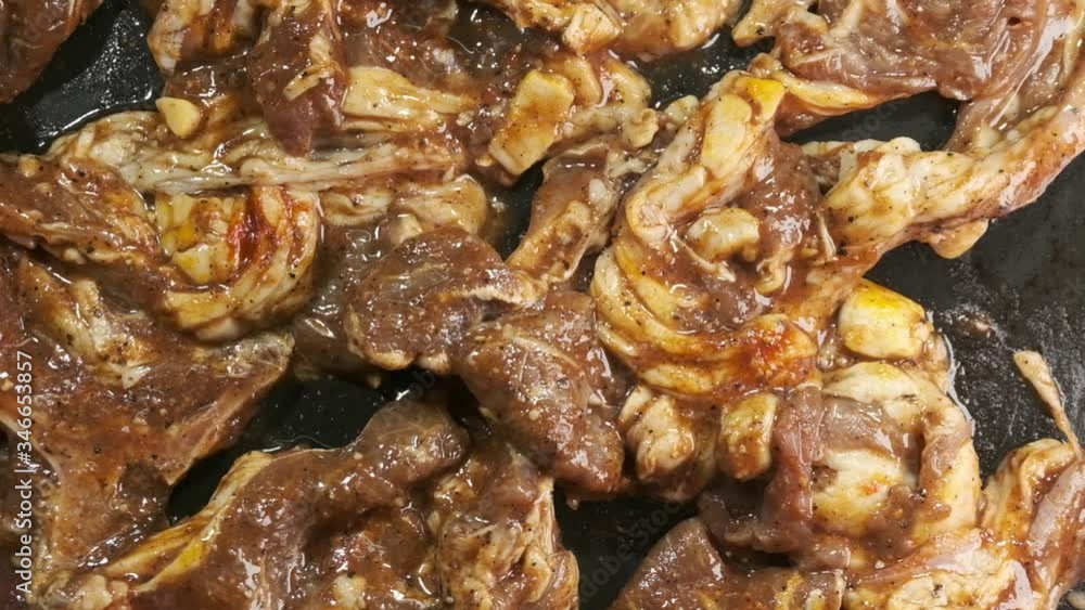 Top down panning slider footage of marinated shoulder mutton on black ...