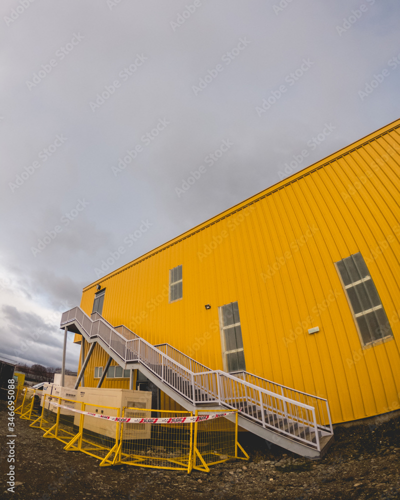 Large yellow metal shed with generators, white stairs, restricted area ...