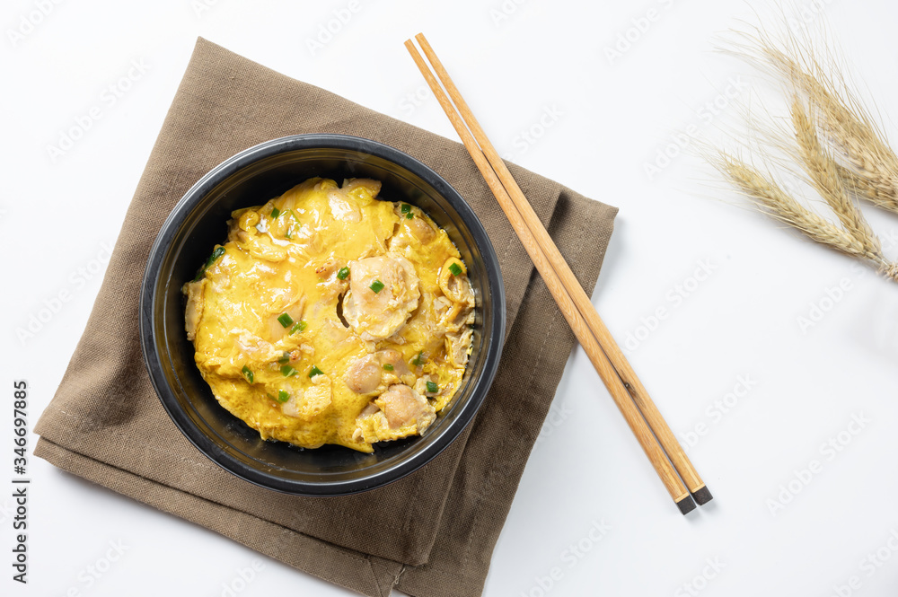 Oyako-don rice bowl topped with chicken, onions and egg cooked with ...