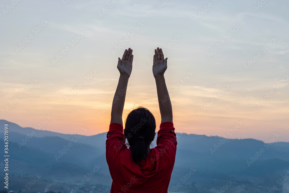 Human with raised hands praying to the GOD with bright sunbeam on the ...