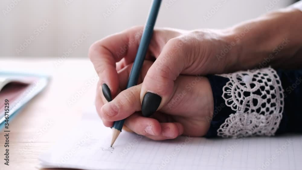 Mother teaches daughter how to write. Little girl holds pencil. Woman ...