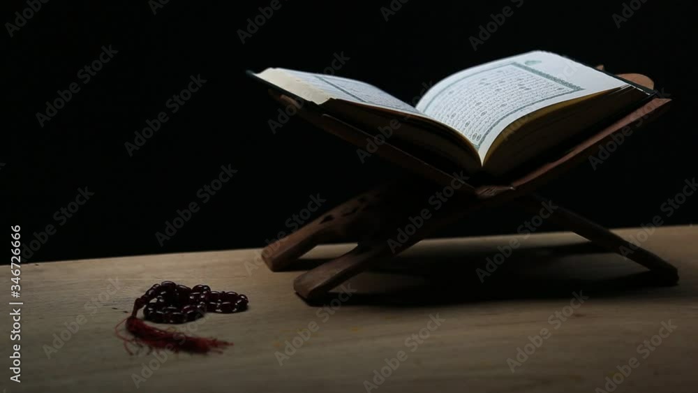 Quran in the mosque - open for prayers The black background of the ...