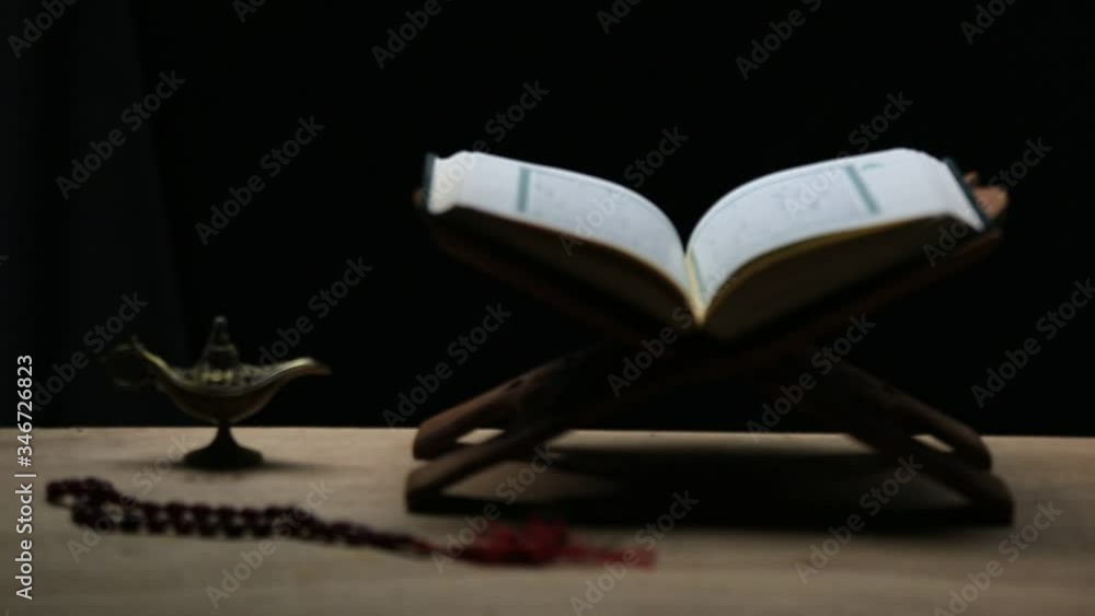 Quran in the mosque - open for prayers The black background of the ...