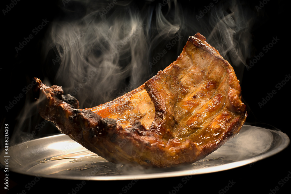 Pork ribs, smoked pork, light play and black background. Ideas for ...