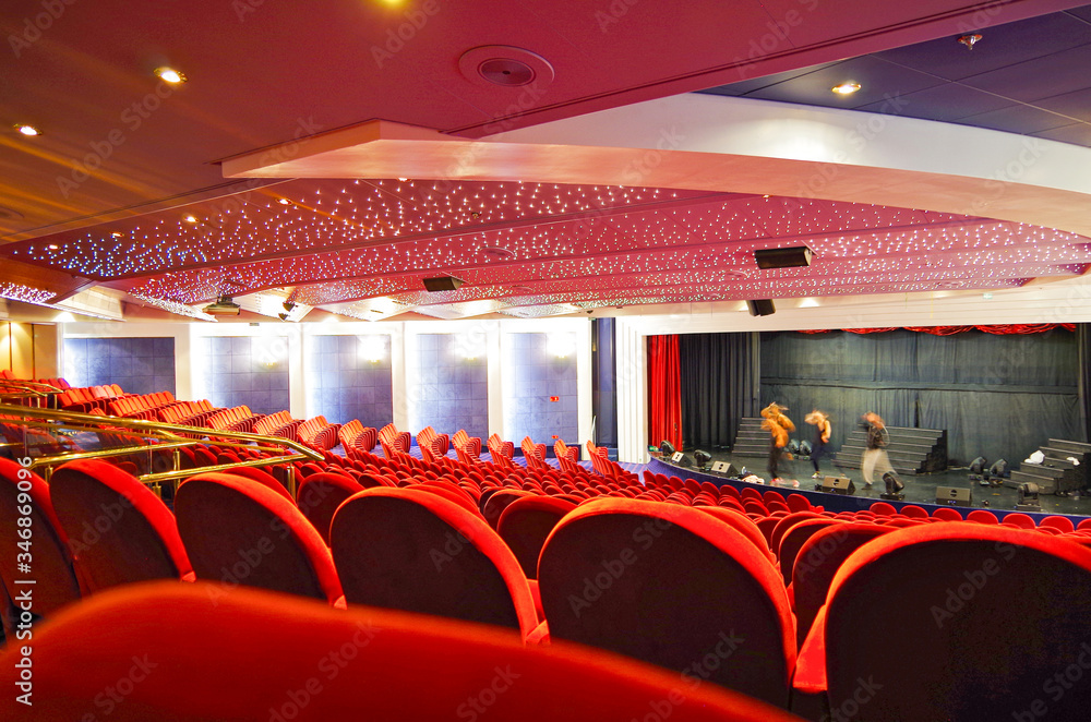 Show Lounge or large theatre with stage and seating in red and blue on ...
