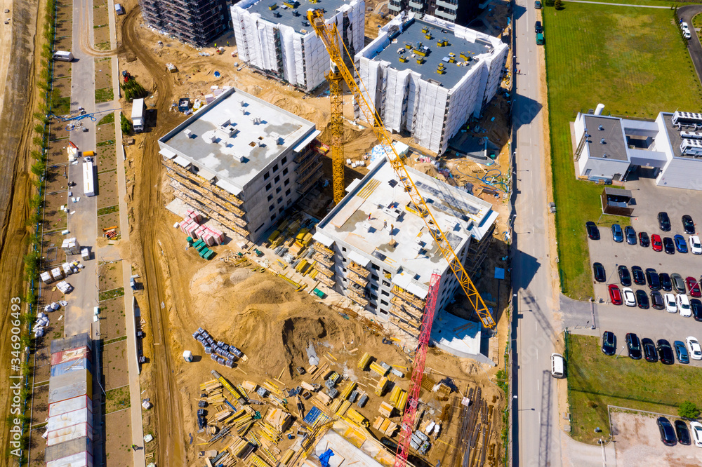Construction site with cranes. Construction workers are building ...