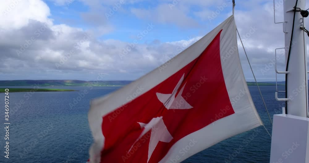 Close up of white Maltese cross on red background flag, the national ...