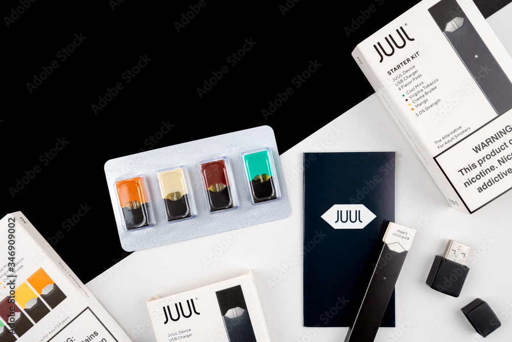 Juul vaping device and juul flavoured nicotine pods, next to usb ...