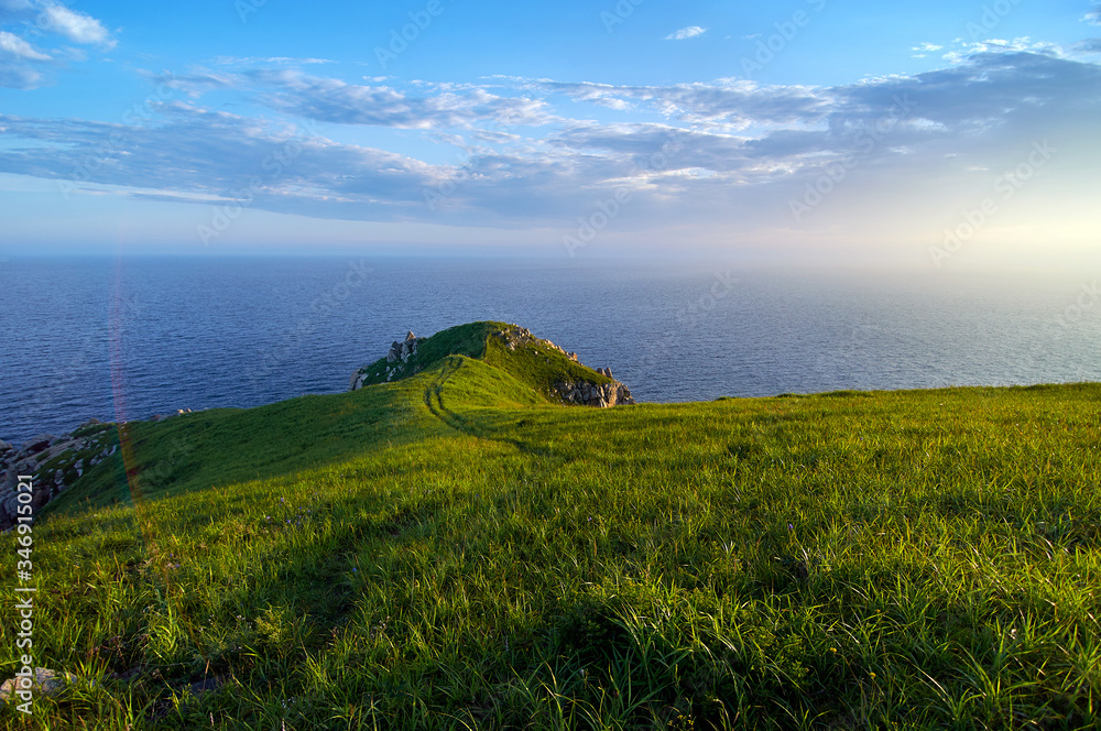 Steep cliff by the ocean. A cliff facing the ocean. View from the cliff ...