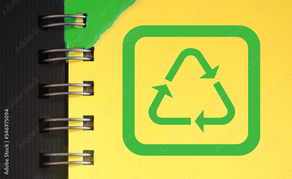 Recycle symbol on a page of spiral copybook. Recycle reuse reduse ...
