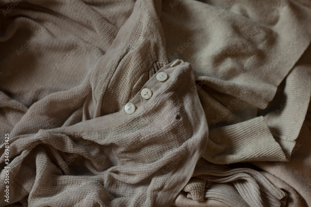 Old clothes in washed out colors laying on a pile. Different pieces ...