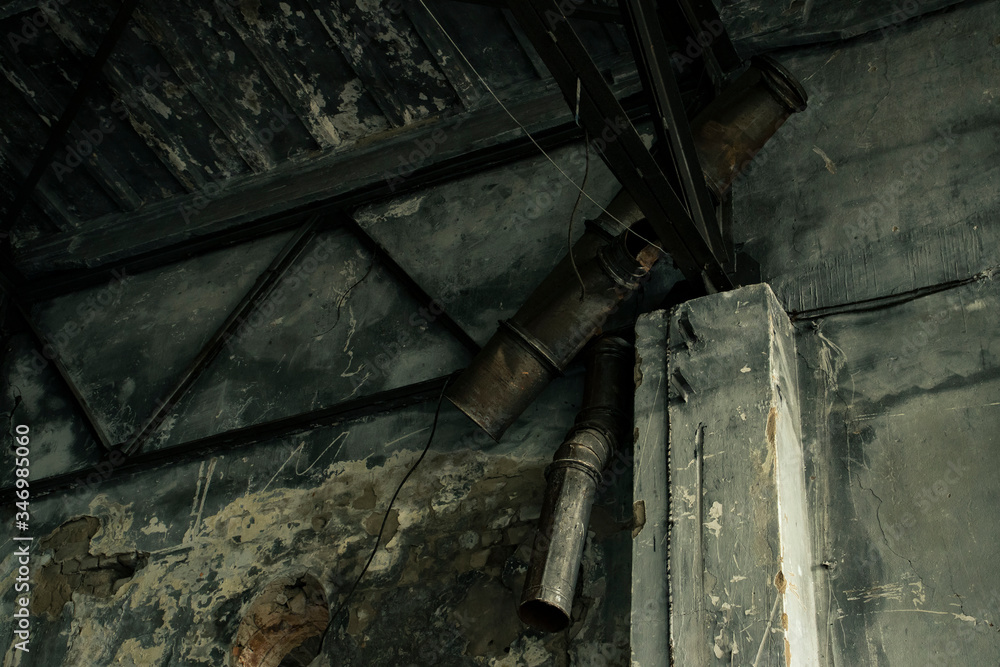 The burnt ceiling of an old, abandoned factory. Part of the ventilation ...