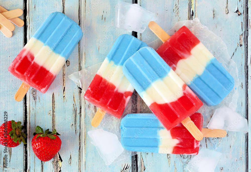 Red, white and blue summer fruit popsicles. Top view table scene on a ...