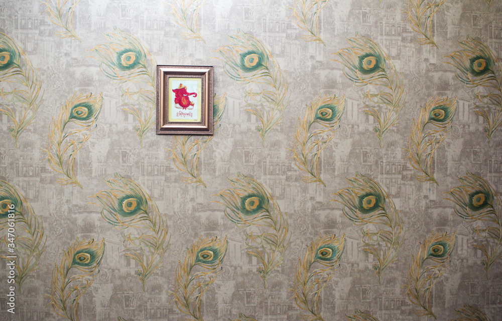 Peacock feather pattern wall with Ganesha frame and open space for text ...
