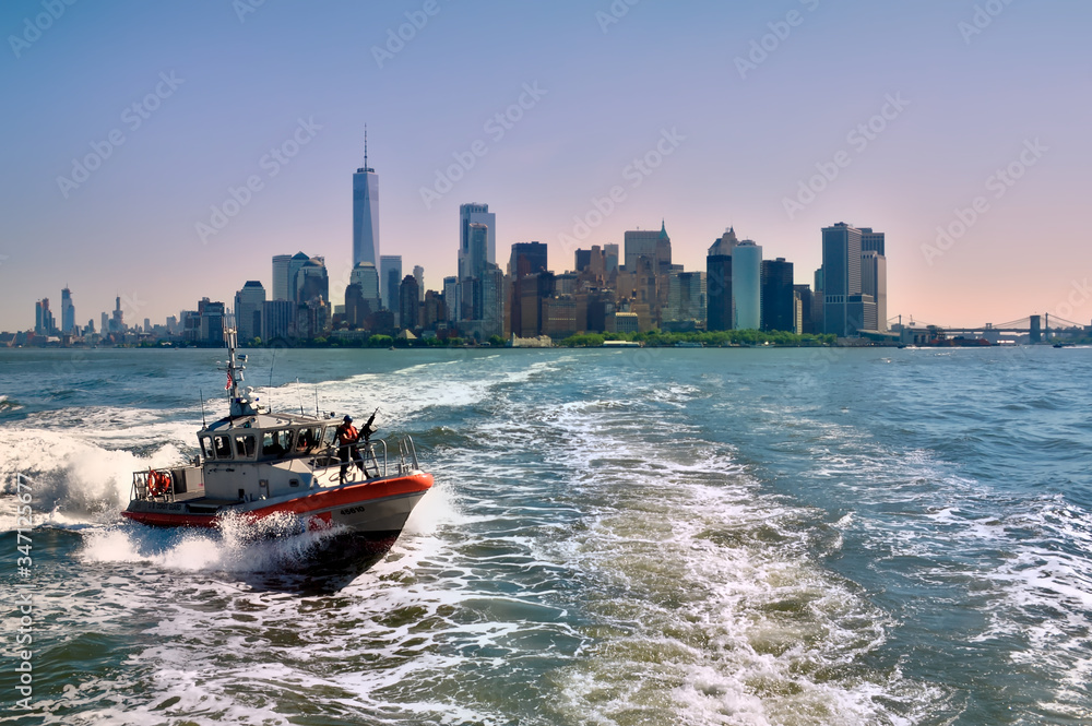 Manhattan cityscape with ocean views and coast guard in the foreground ...